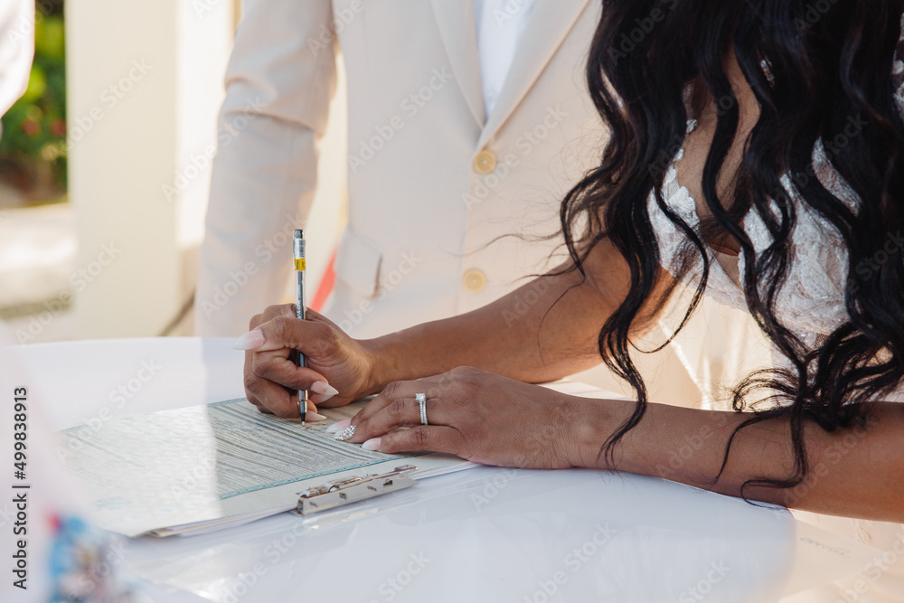 Bride and Groom Signing Marriage Certificate Bride hand with a pen ...