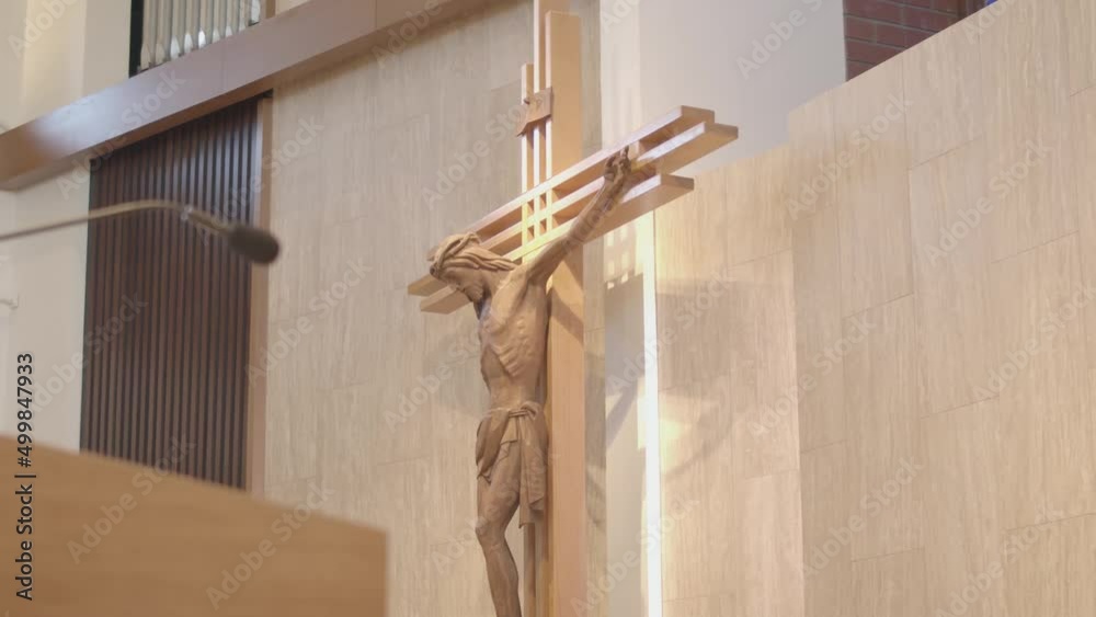 A dynamic footage of a church crucifix moving towards the left ...