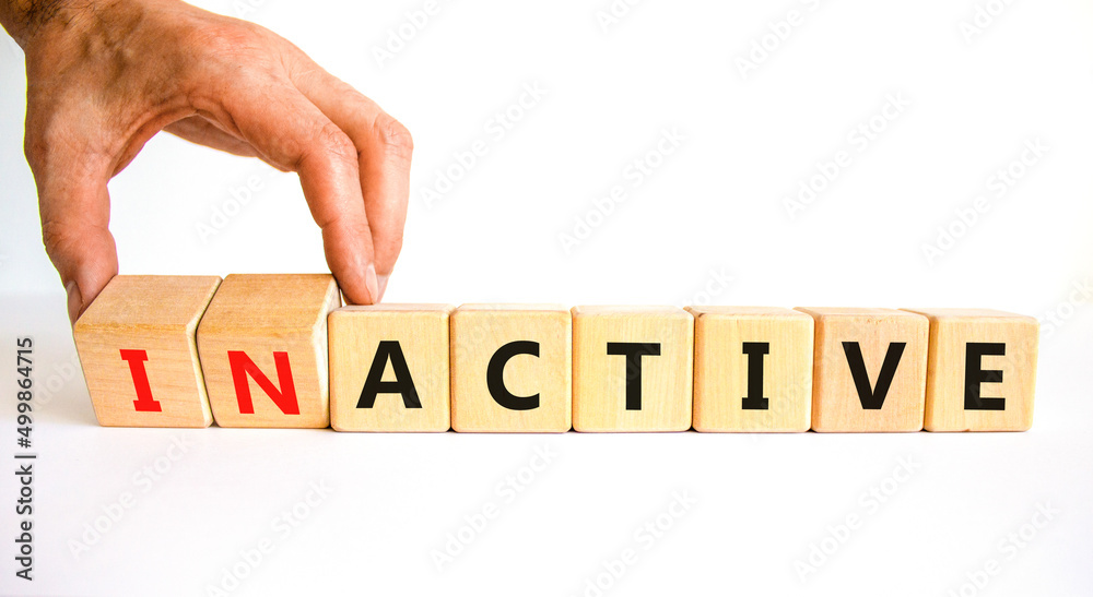 Active or inactive symbol. Businessman turns wooden cubes and changes ...