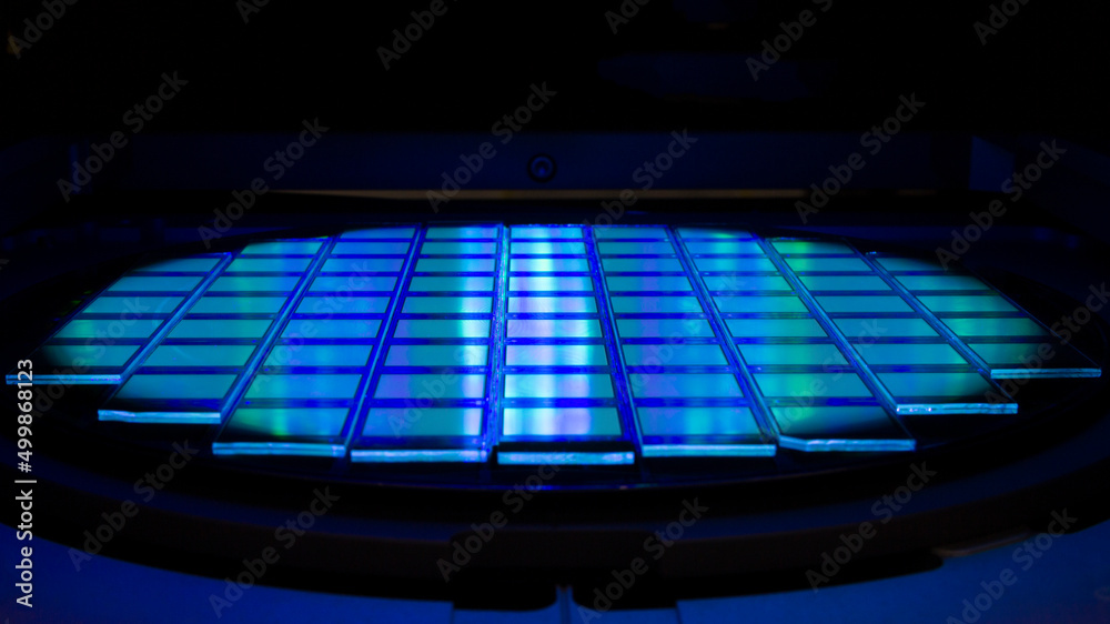 Silicon wafer with chips in UV lighting. Neon. Ultraviolet Lithography ...