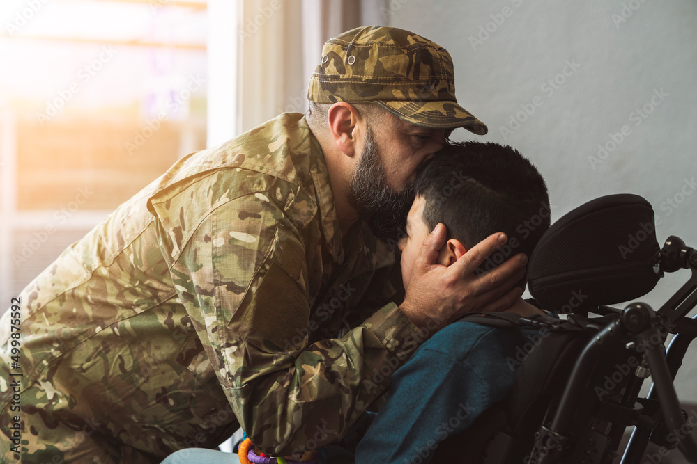 military soldier father kisses his disabled son. happy with autism ...