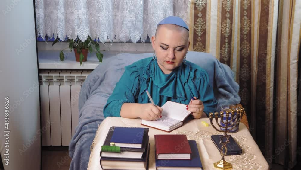A woman rabbi of the Reform Jewish community, shaved bald in a kippah ...