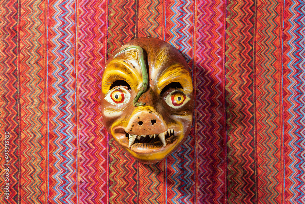 Typical devil Cusco´s mask on a traditional peru fabric Stock Photo ...