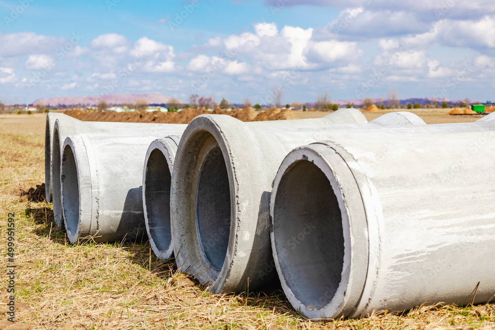 Reinforced concrete storm sewer pipes of large diameter stacked at a ...