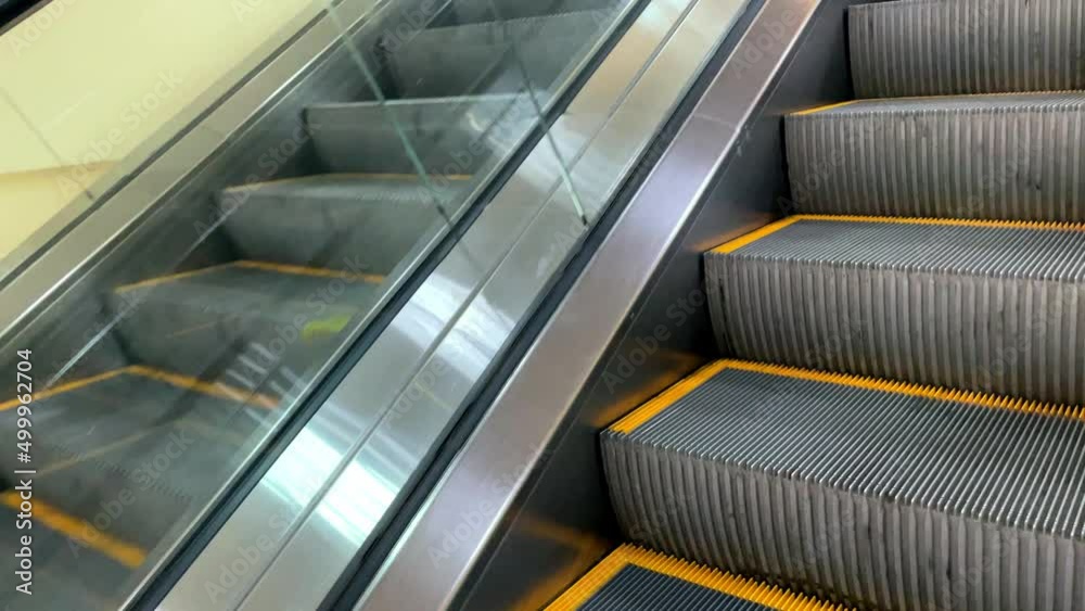 Close-up of empty escalator steps moving up and down. Escalator footage ...