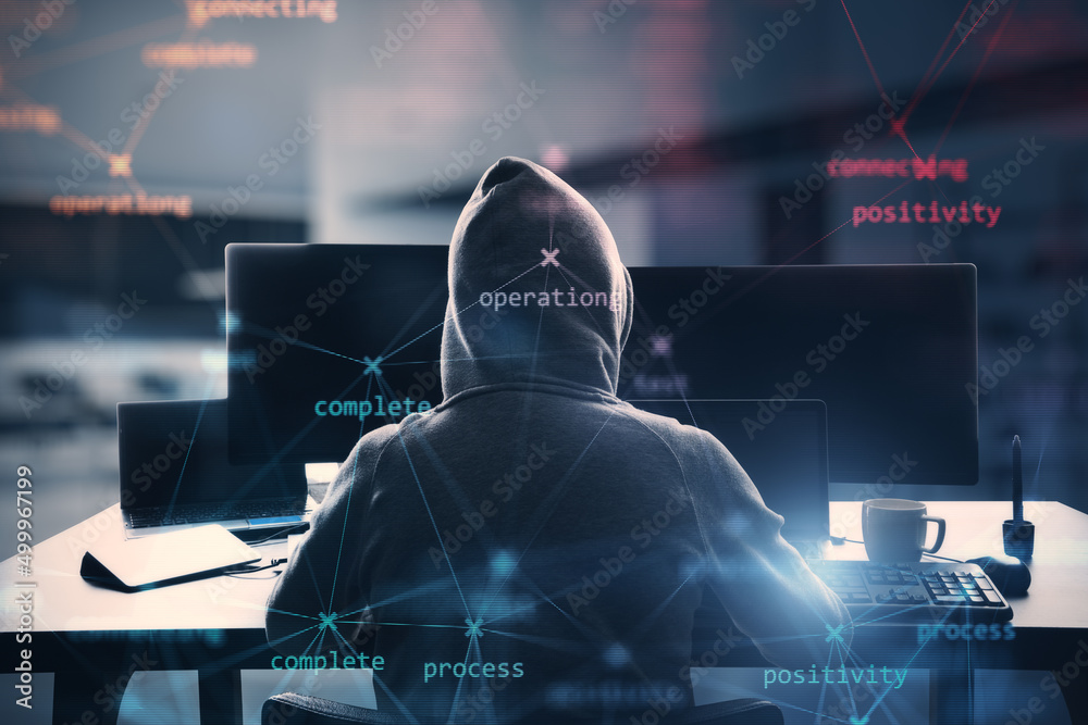 Back view of hacker at desktop using computers with creative process ...