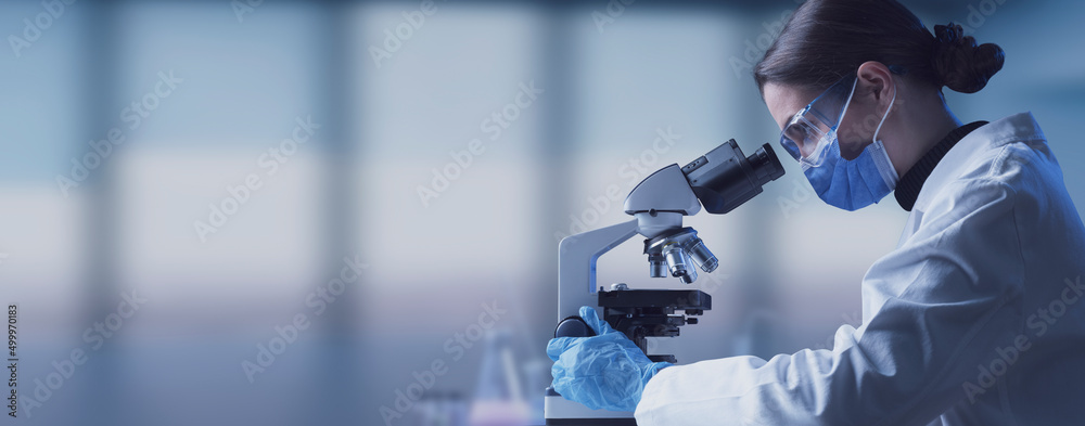 Researcher using a professional microscope Stock Photo | Adobe Stock