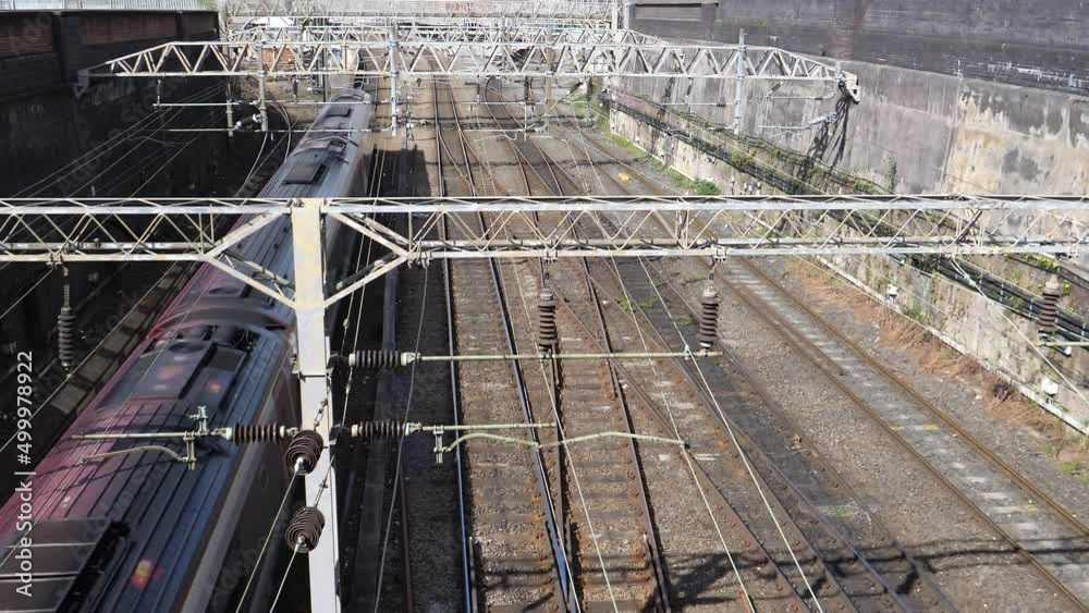High angle view of railway or railroad tracks between concrete walls ...