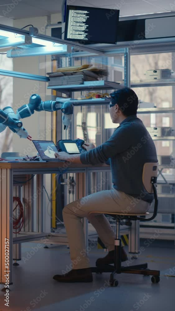 Professional Young Developer Coding at Laptop and Manipulate of Robot ...