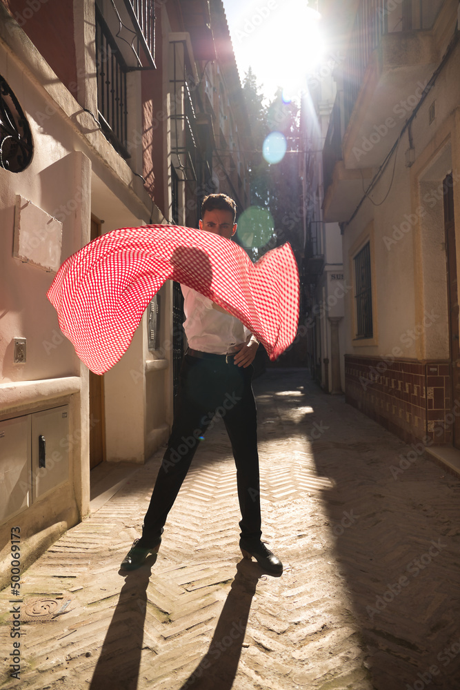 Young Spanish man in white shirt and black dance pants and shoes ...