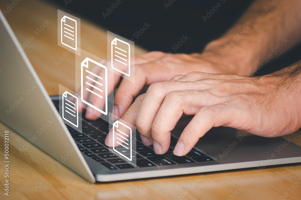 Hand with document icons and typing to laptop computer. Managing ...