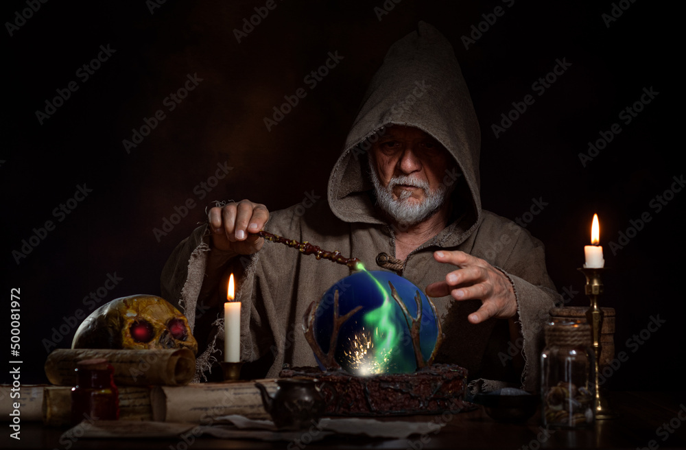 Medieval wizard cast magic with magic wand and crystal ball Stock Photo ...