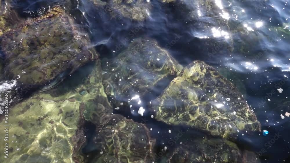 The sun is reflected in the waves. Stone blocks in the sea. The stones ...