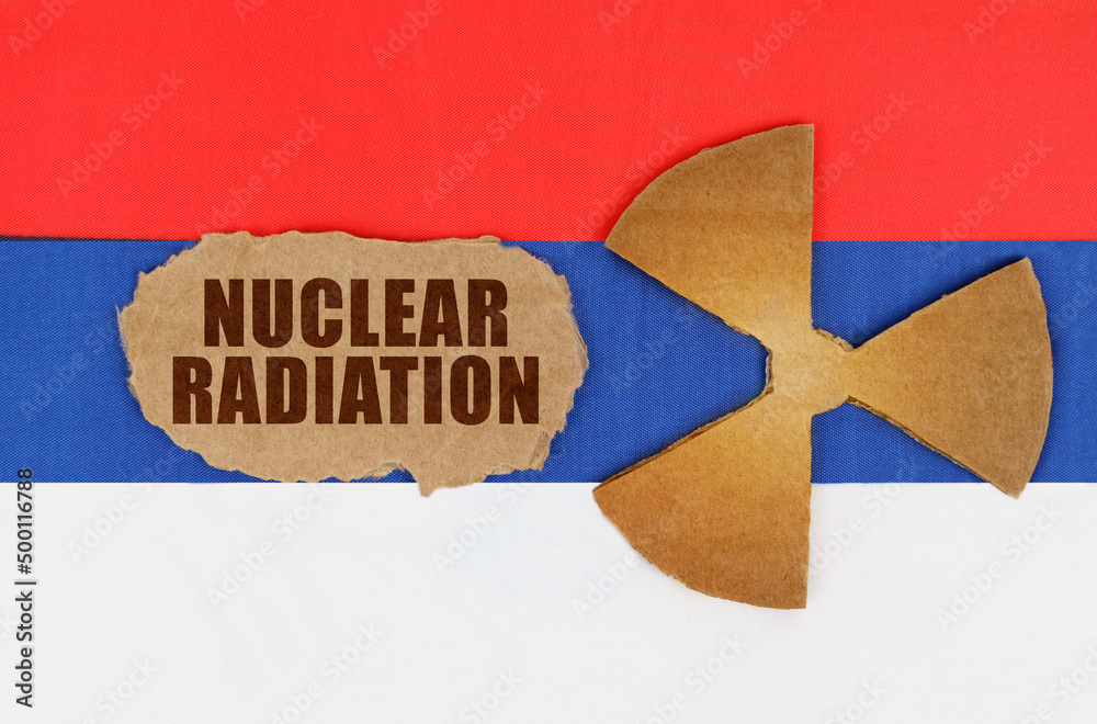 On the flag of Russia, the symbol of radioactivity and torn cardboard ...