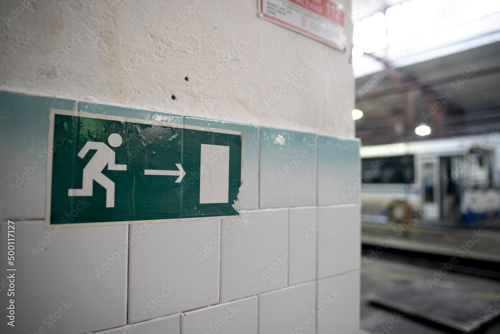 Exit sign during a fire with a graphic of a person and a ladder on the ...