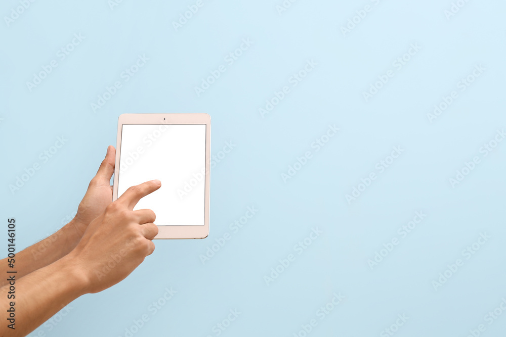 Male hands with modern tablet computer on color background Stock Photo ...