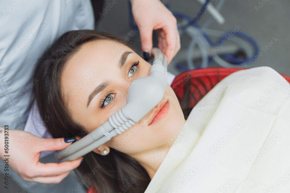 dentist puts inhalation sedative mask on his patient. Stock Photo ...