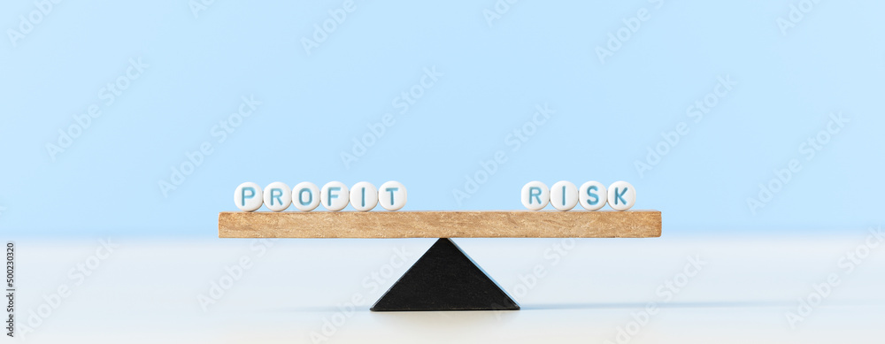 Risk and profit words on scale. Risk management concept and a risk ...