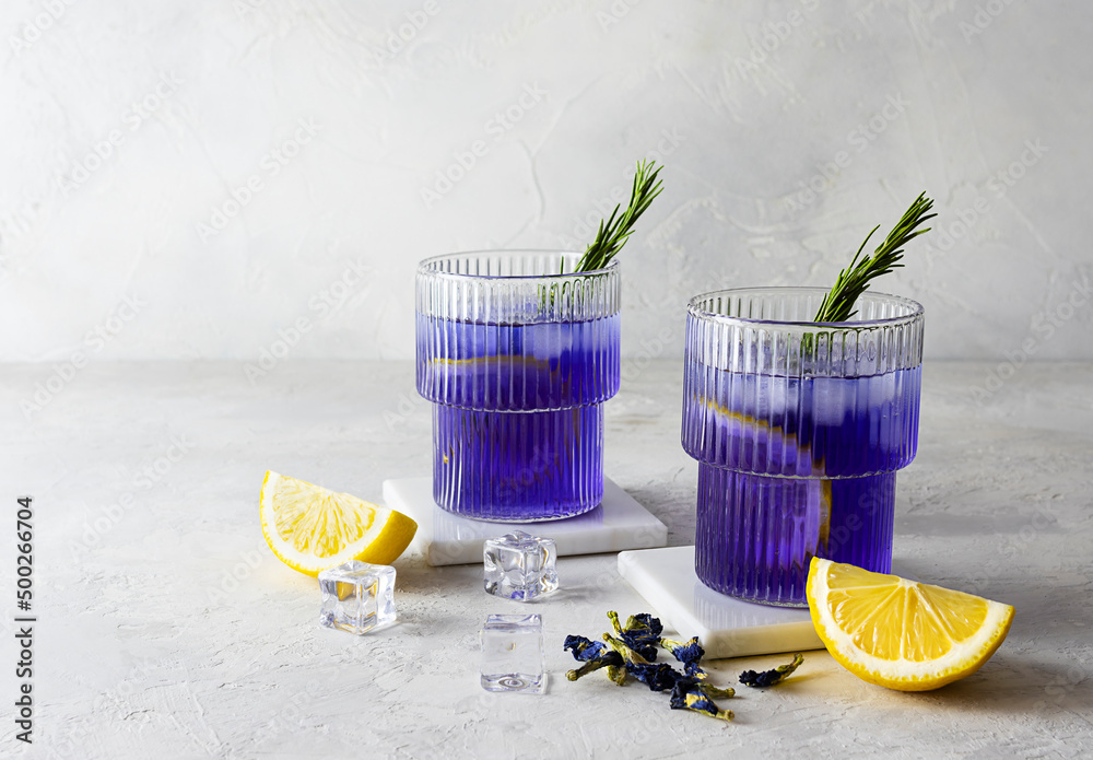 Blue iced tea from clitoria flowers in transparent glasses on marble ...