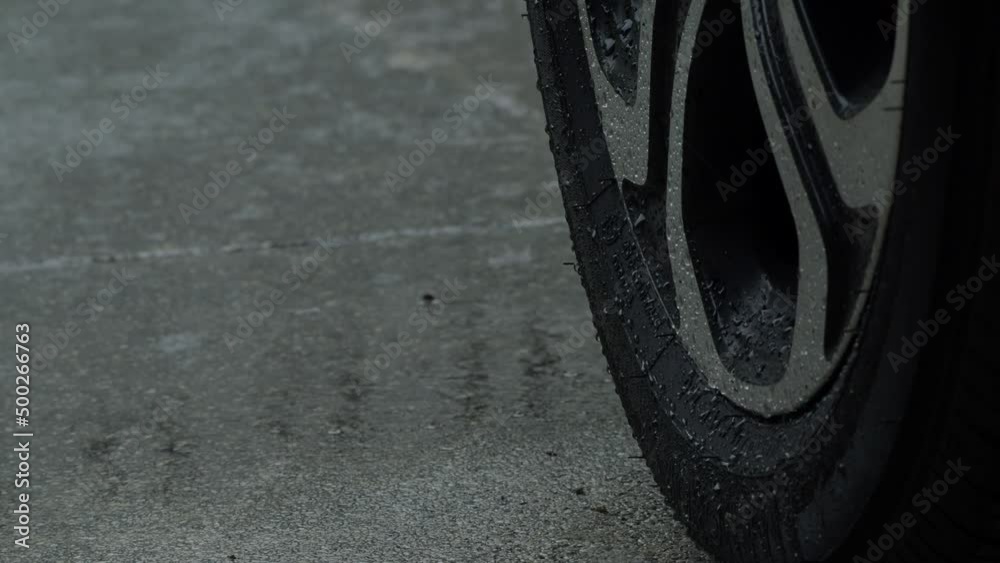 Rain splashing and car tire in rainwater. Car parking in the rain ...