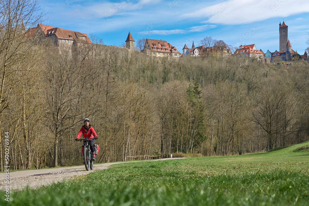 nice woman on a cycling tour on the famous German route of castles ...