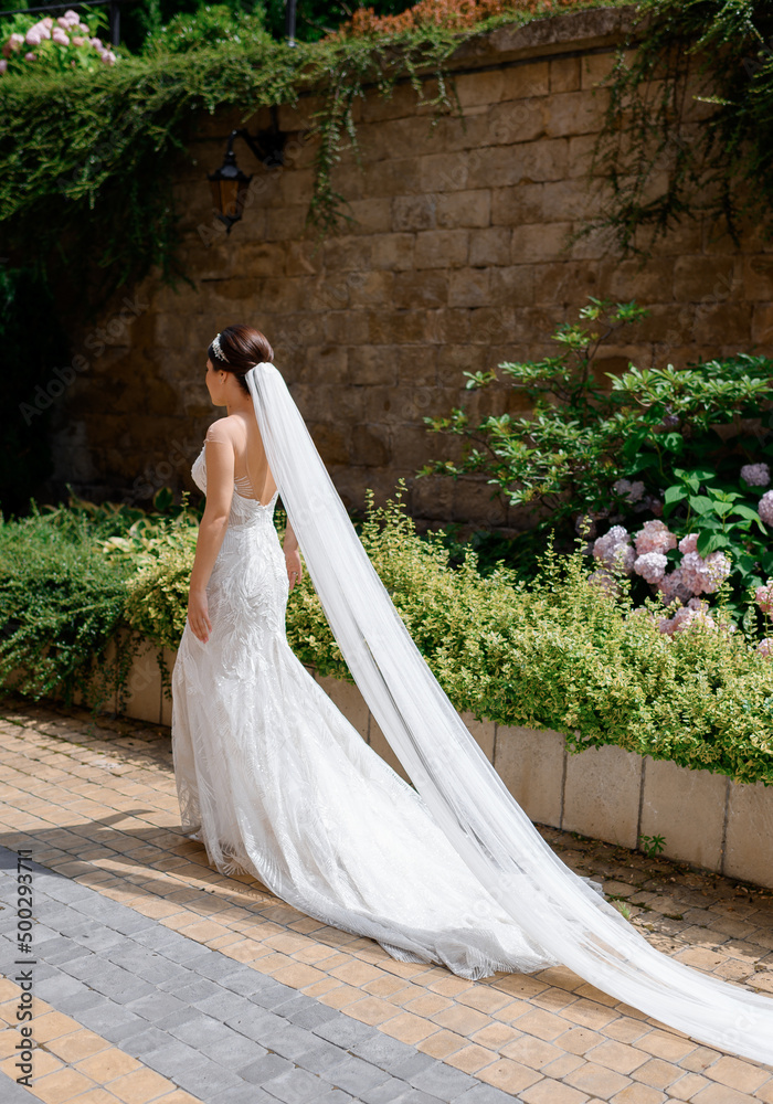 Side view of faceless bride, wearing in lace wedding gown with ...