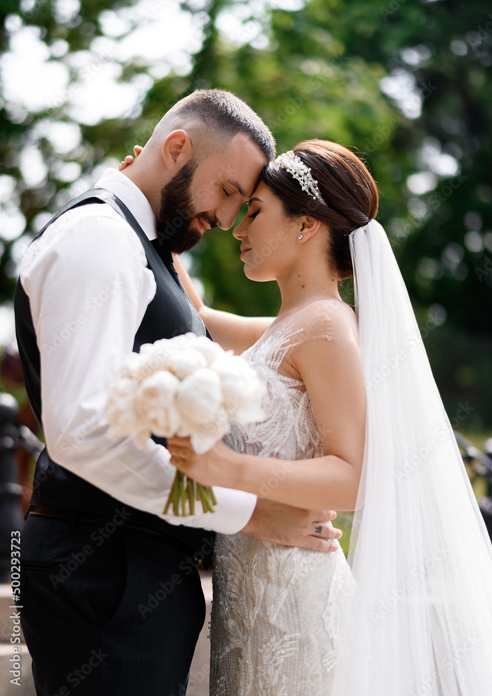 Side view of beautiful bride and groom, standing face to face ...