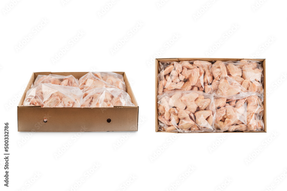 Raw, frozen chicken wings in a cardboard box on an isolated white ...