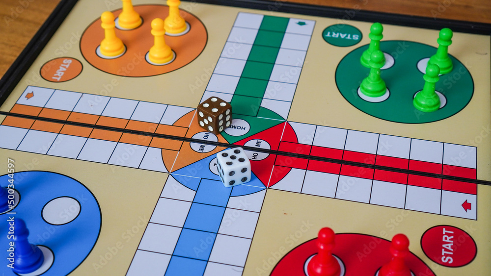 Ludo board game with two dice and four players in red, blue, yellow and ...