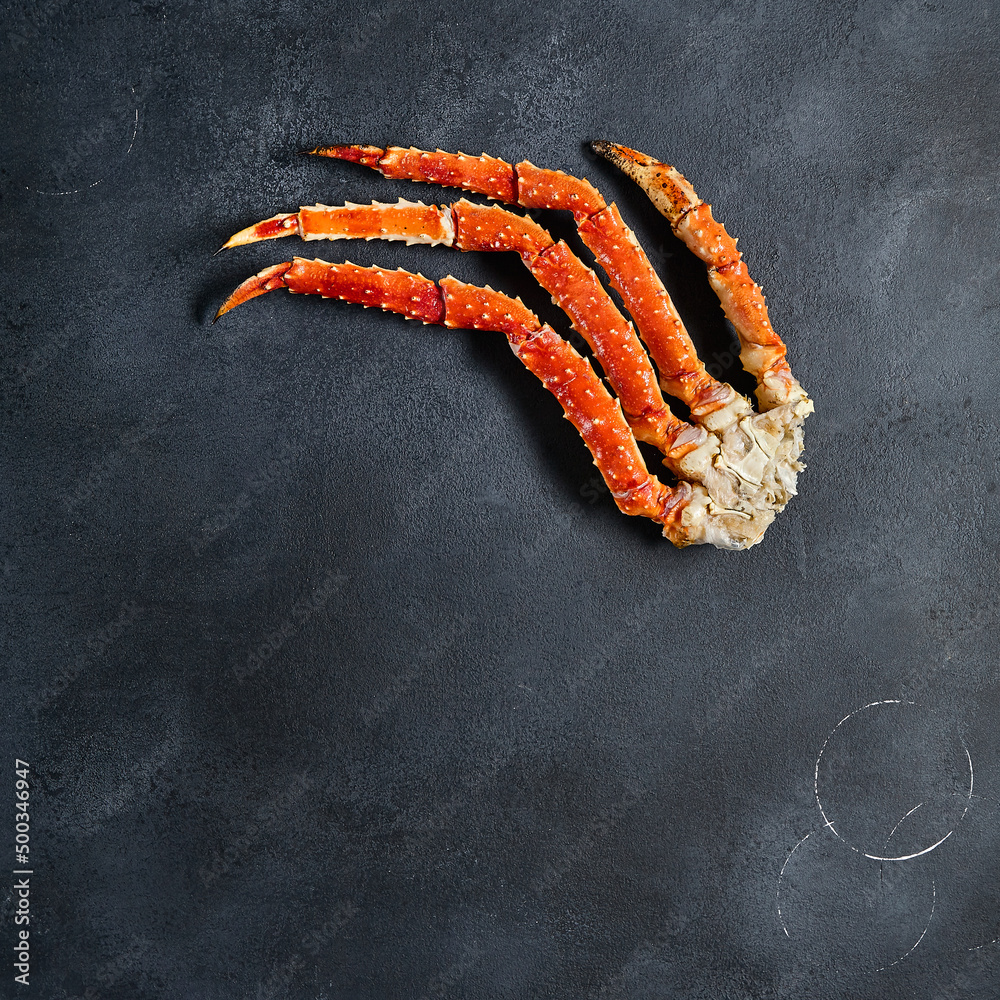 Crab legs top view on dark background. Delicatessen crab seafood on ...