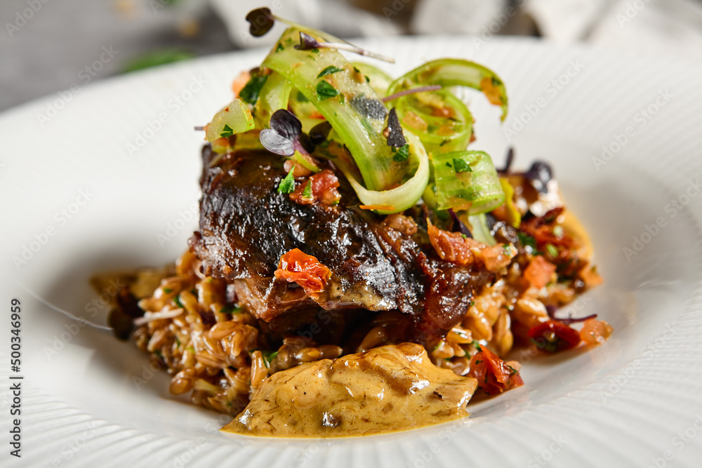 Braised beef cheeks with pearl barley and celery in creamy mushroom ...