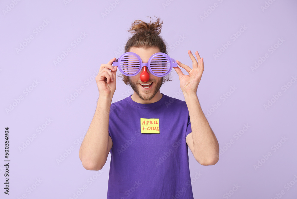 Funny man in disguise and with sticky note on his clothes against lilac ...