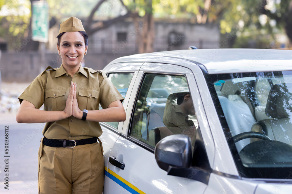 Portrait of a proud female taxi driver greeting in prayer pose with her ...