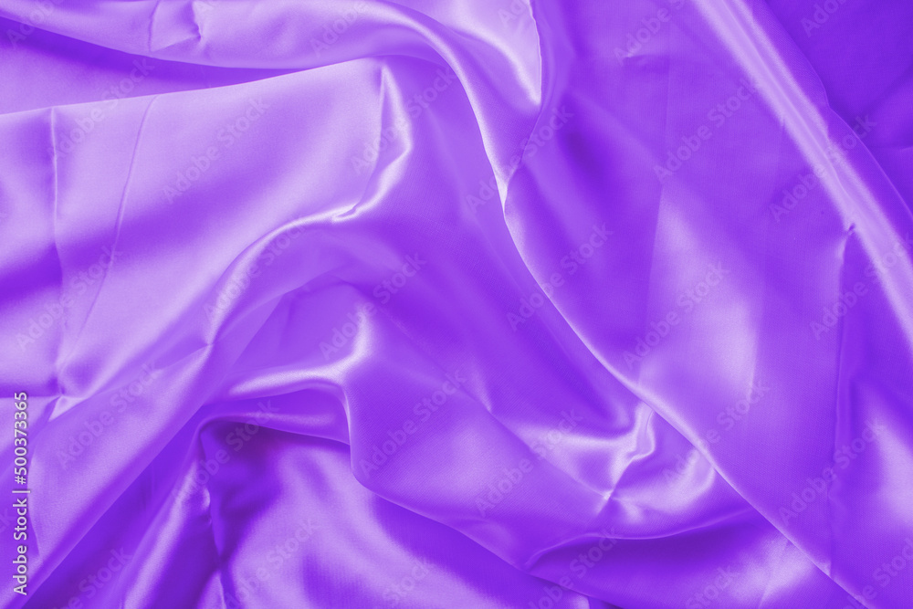 The wrinkled surface of the proton purple cloth. The purple shiny cloth ...