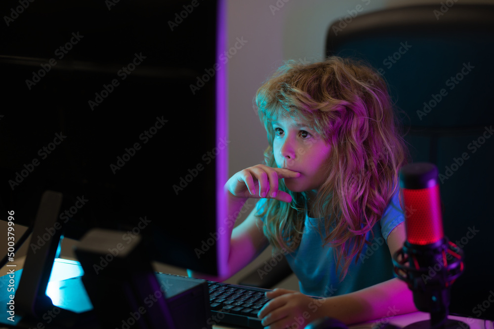 Little kid using desktop pc by night, child boy illuminated by the blue ...