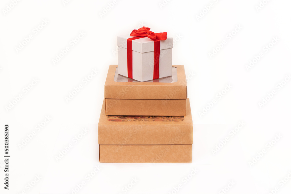 Mocap. A stack of three gift boxes led by a white box and a red bow ...