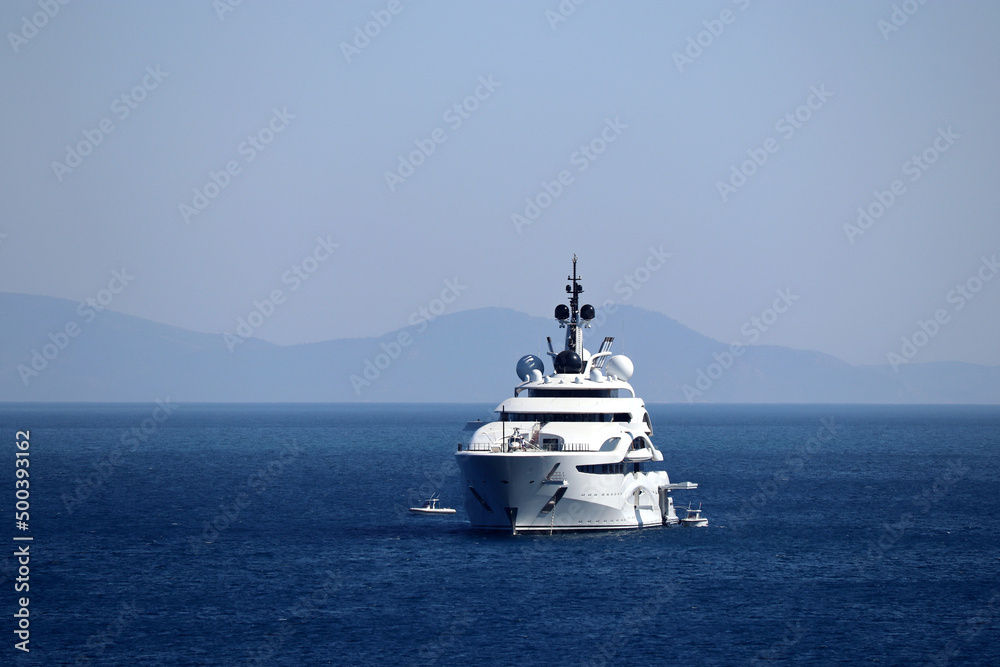 Luxury yacht with helipad and helicopter sailing in a sea, front view ...
