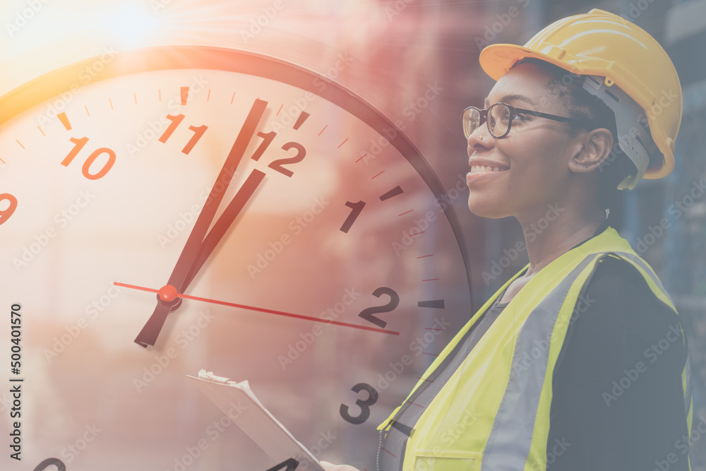 Engineer black smart woman worker in factory overlay with time clock ...