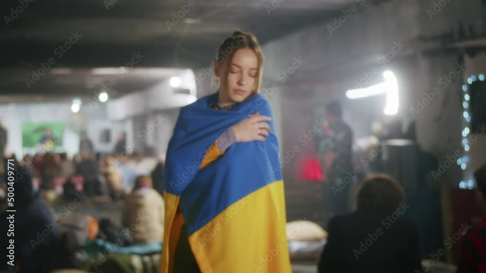 Portrait of a sad Ukrainian woman in a bomb shelter with the Ukrainian ...