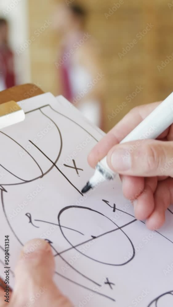 Hands of basketball coach drawing diagram on clipboard Stock Video ...