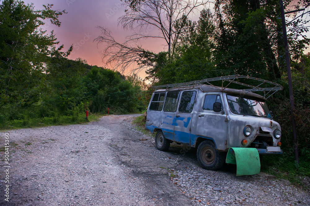 The concept of an SUV in the mountains. Minibus. Post-apocalyptic look ...