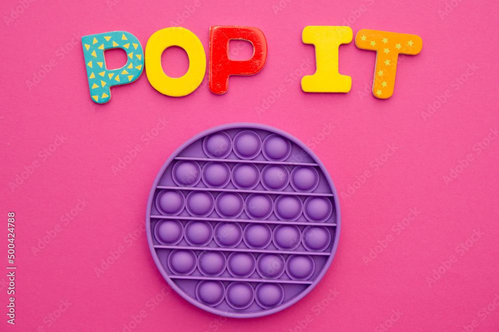 Sensory fidget toy "Pop-it". Instrument for fine motoric skils, tool to ...