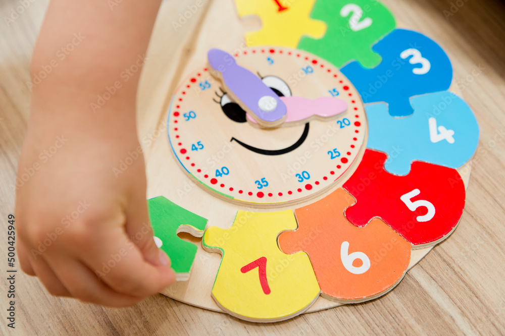 Boy learning time with wooden clock. Toy for Learning method for ...