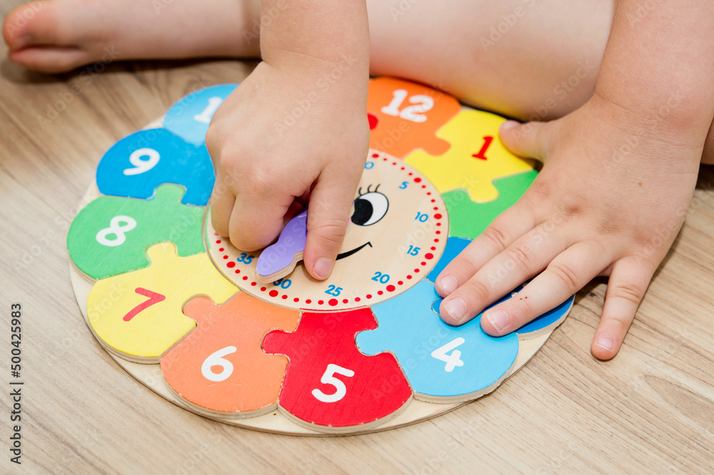 Boy learning time with wooden clock. Toy for Learning method for ...