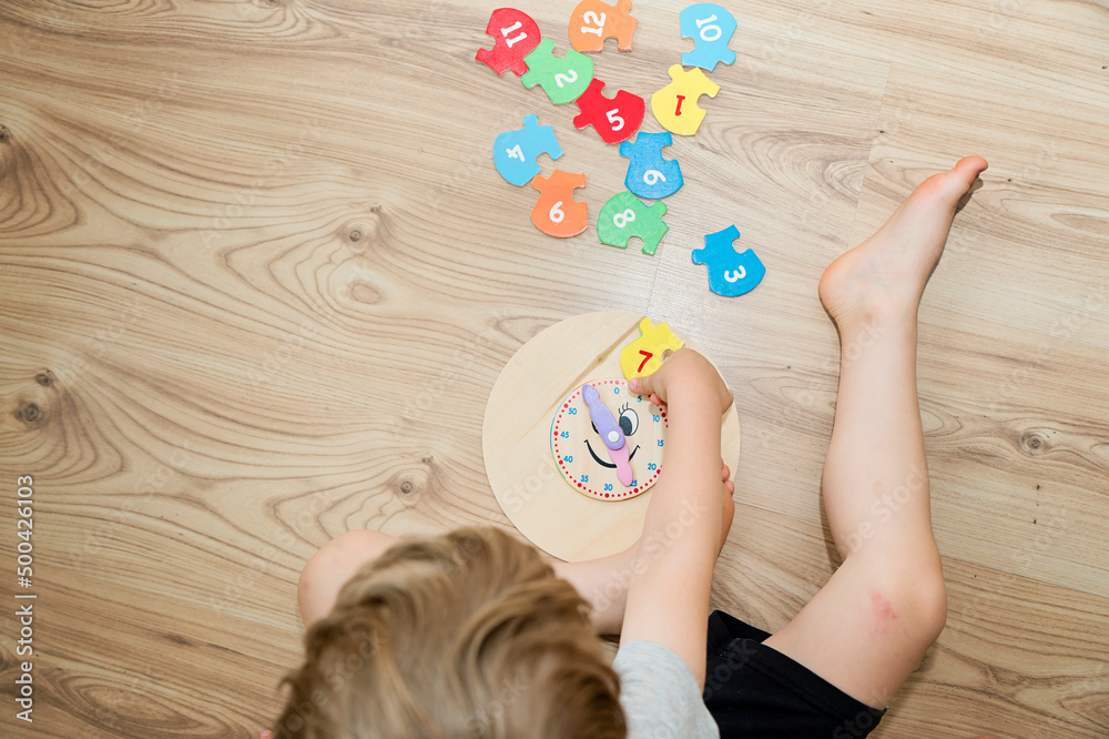Boy learning time with wooden clock. Toy for Learning method for ...