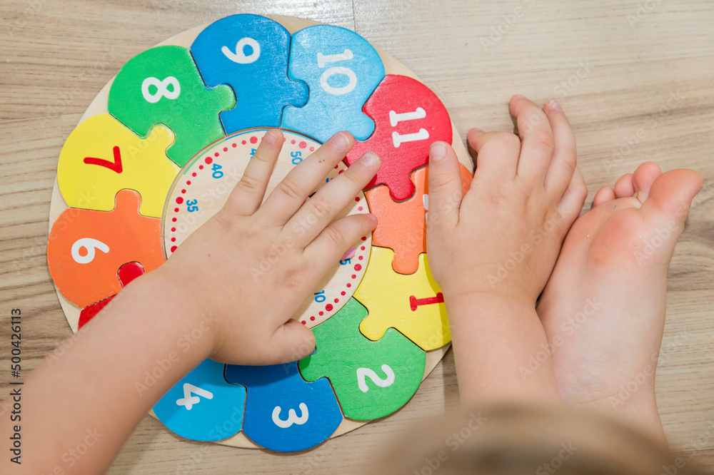 Boy learning time with wooden clock. Toy for Learning method for ...