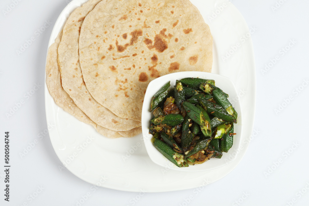 Bhindi masala or ladies finger fry served with indian roti chapati or ...