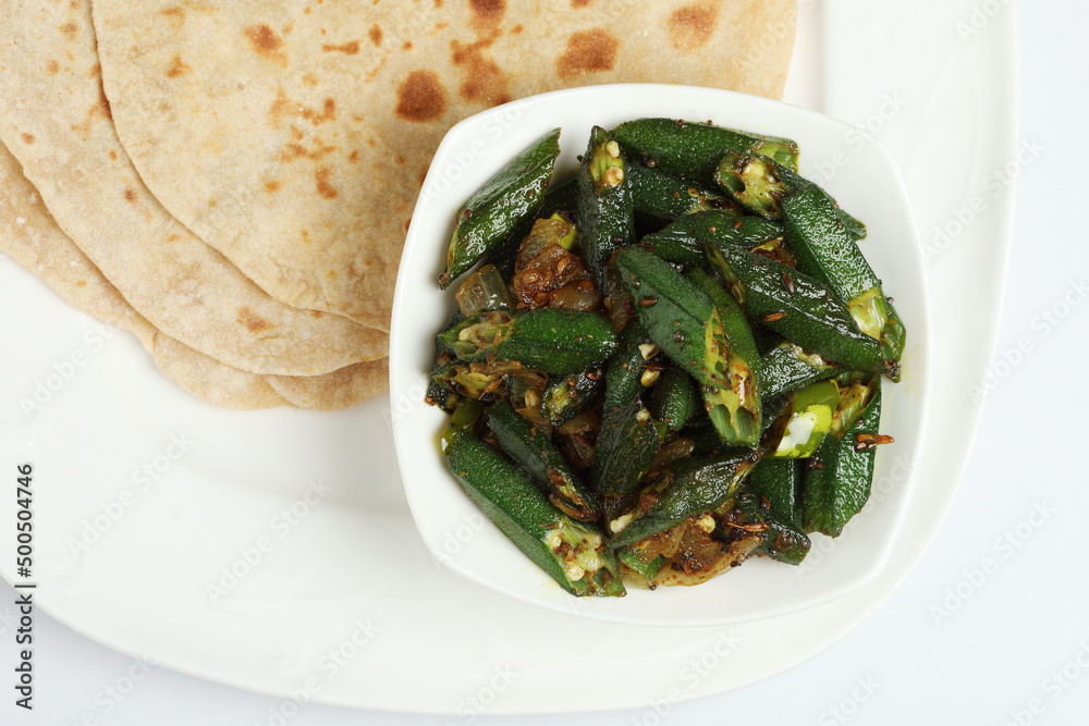 Bhindi masala or ladies finger fry served with indian roti chapati or ...