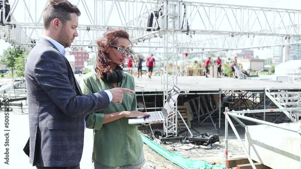 Event managers discuss stage construction. Installation of stage ...
