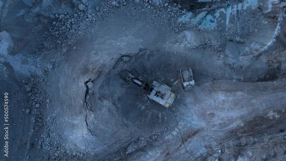 Excavator load limestone in mining truck in open pit mine. Haul truck ...